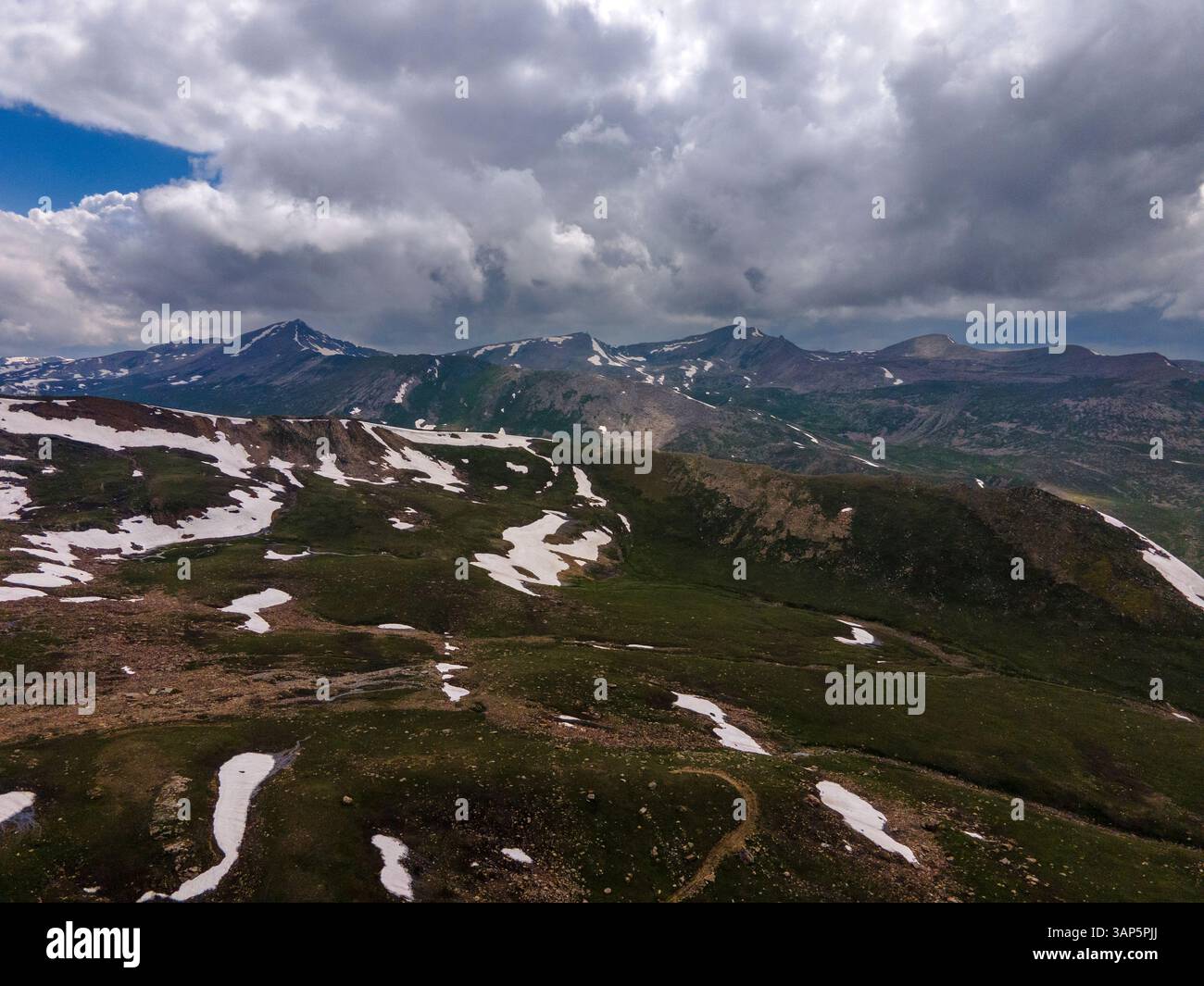 Aerial view of majestic snowy mountains under dramatic clouds in a ...