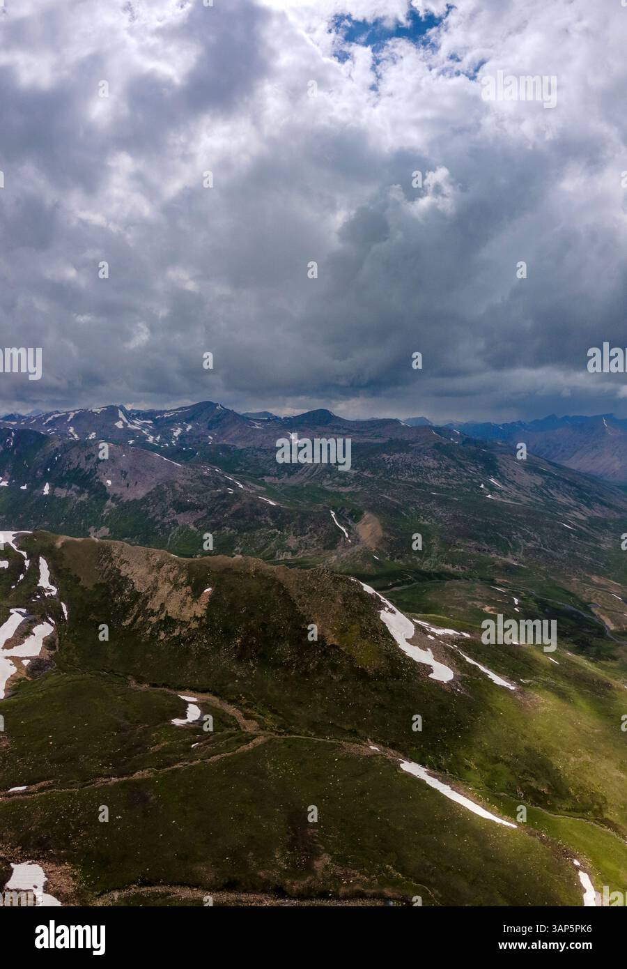 Aerial view of majestic rugged mountains and a serene valley under ...