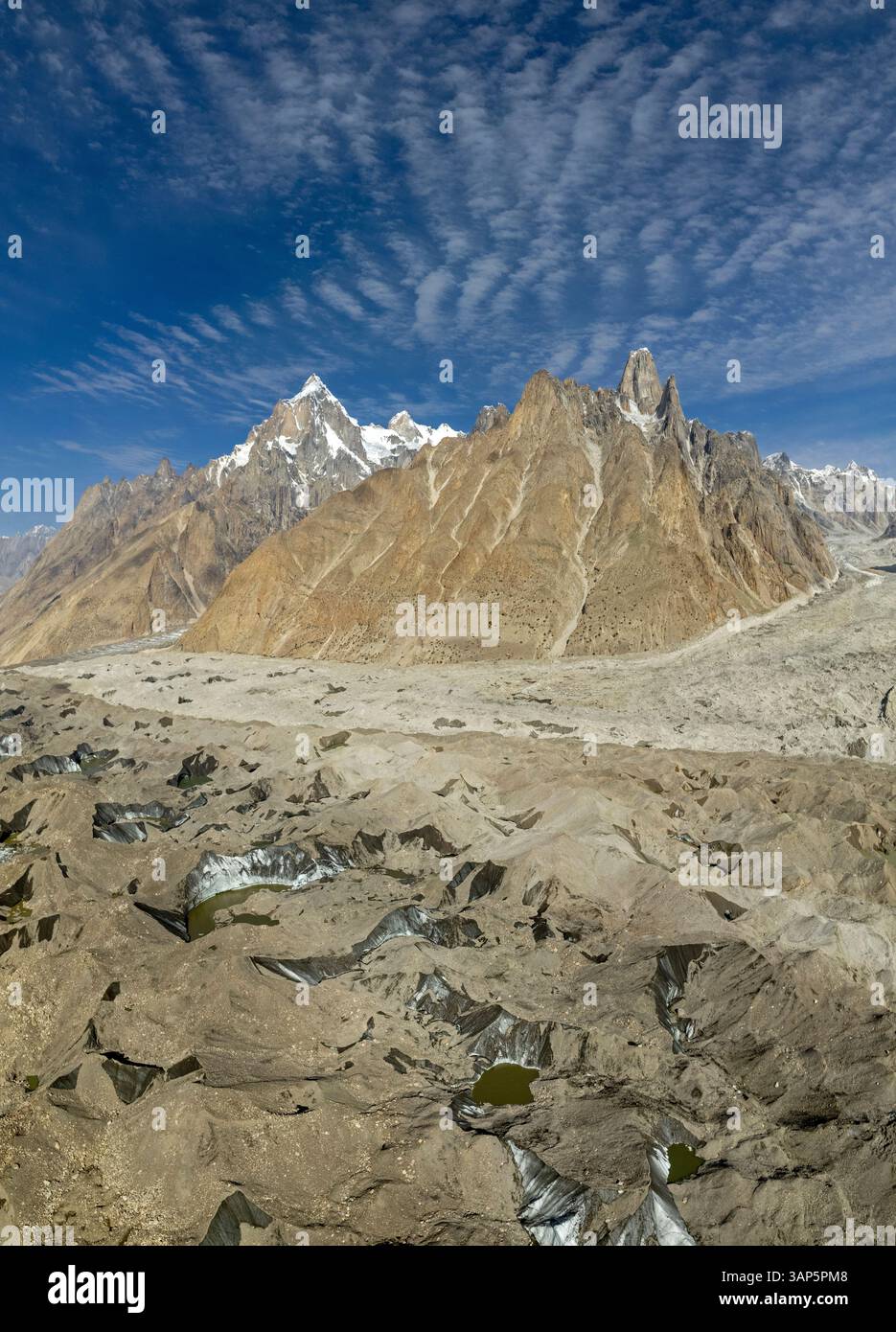 Aerial view of majestic snow-covered mountains and glaciers under a ...