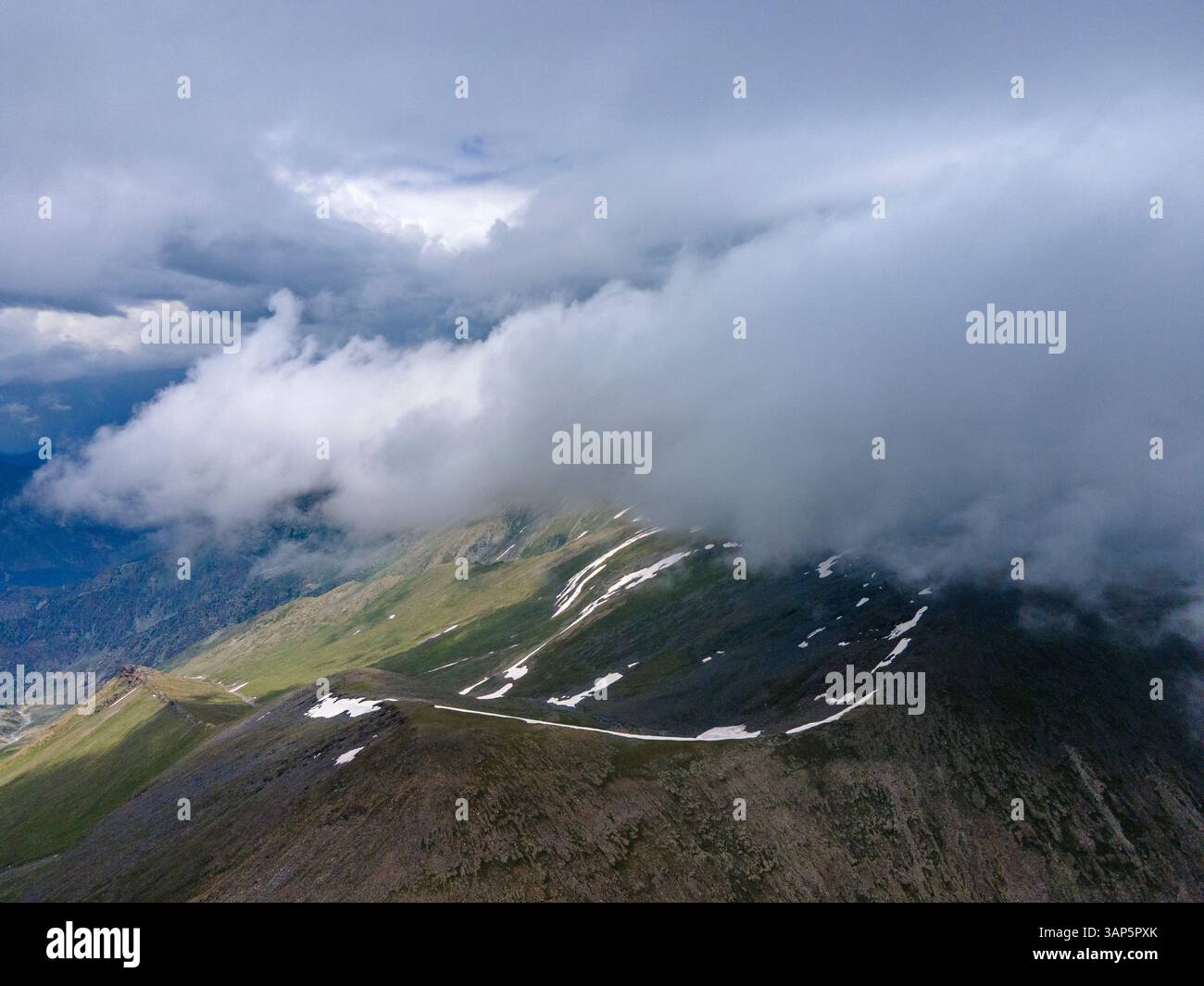 Aerial view of majestic snowy mountains and clouds at Babusar Pass ...