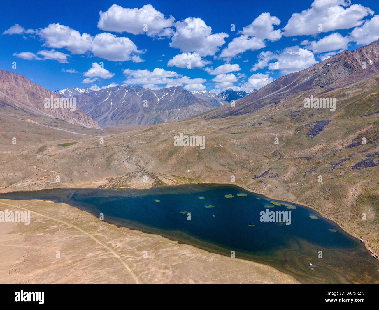 Aerial view of pristine Shandur Lake surrounded by majestic mountains ...
