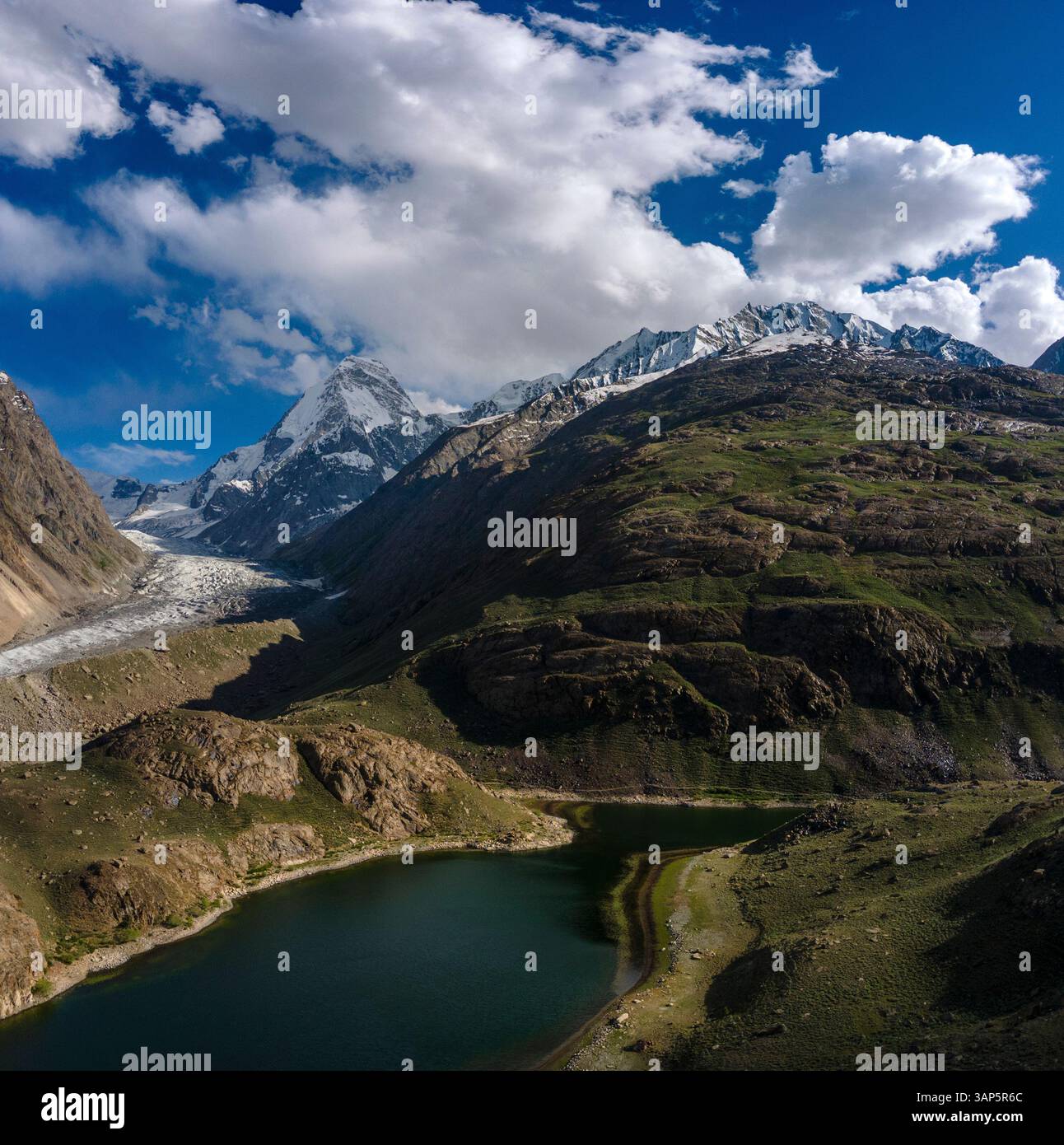 Aerial view of majestic snow-capped mountains and a pristine lake in ...