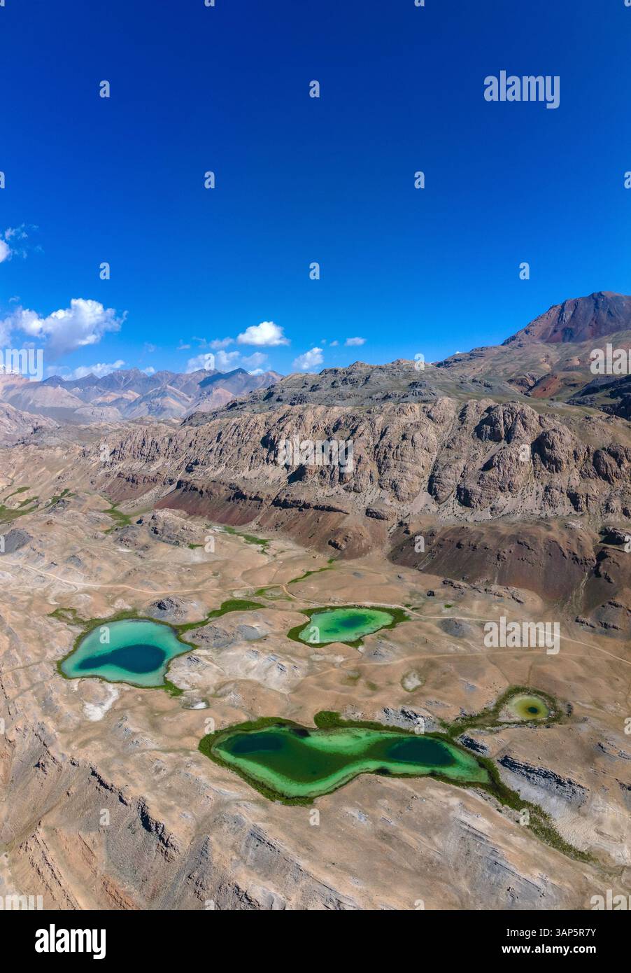 Aerial view of majestic mountains and pristine lakes under a clear blue ...