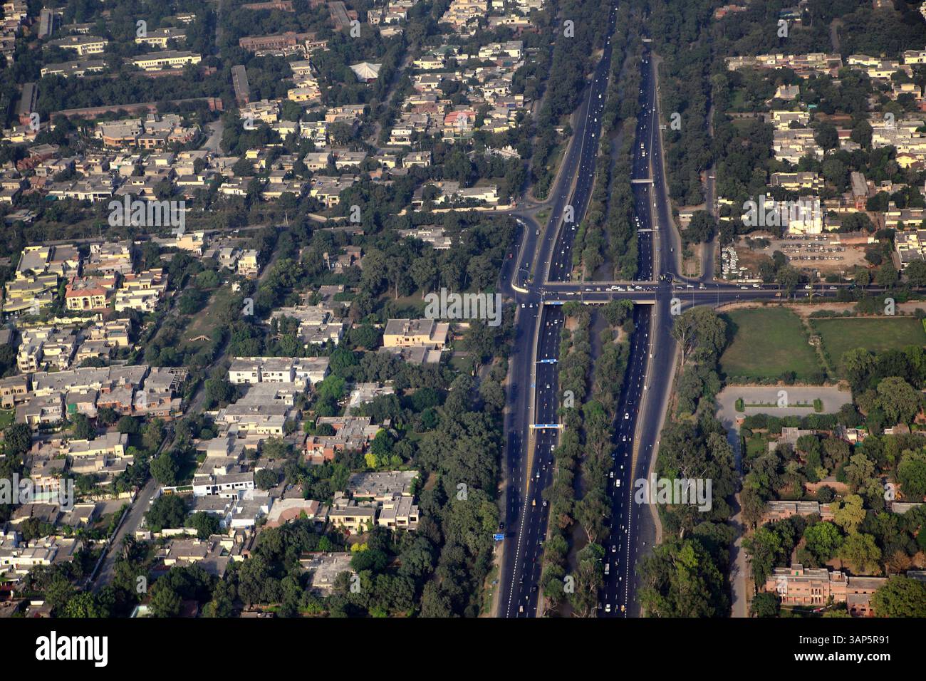 Aerial view of urban landscape with tree-lined roads and residential ...