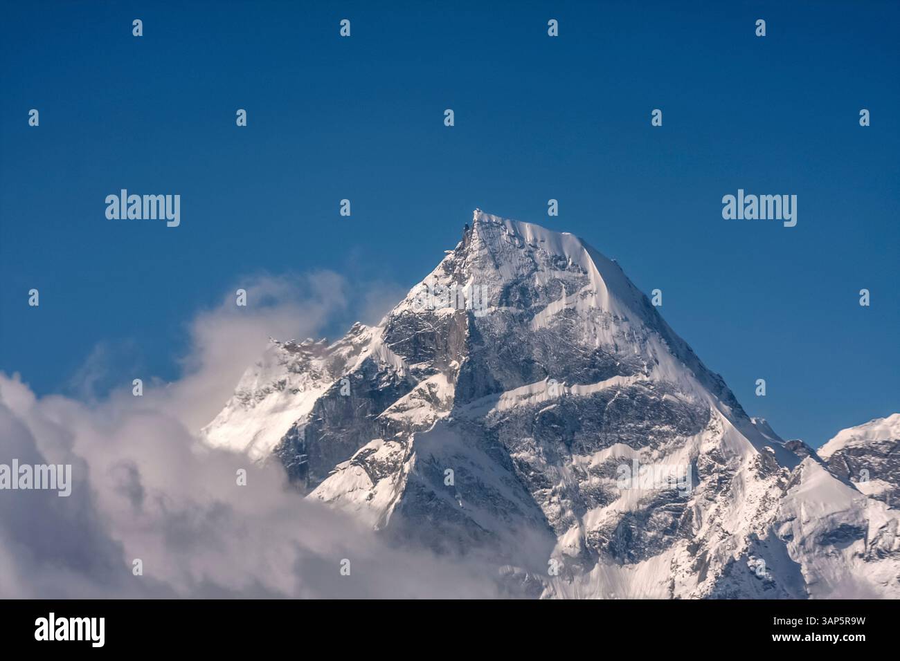 Aerial view of majestic snow-capped peaks under a dramatic sky in the ...