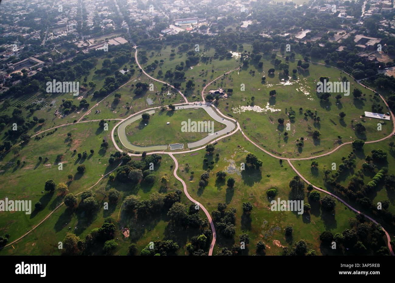 Aerial view of tranquil urban park with green trees and pathways ...