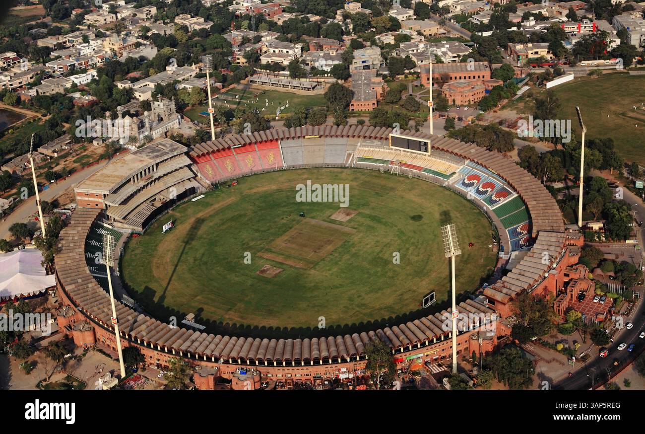 Aerial view of a vibrant stadium surrounded by lush trees and urban ...