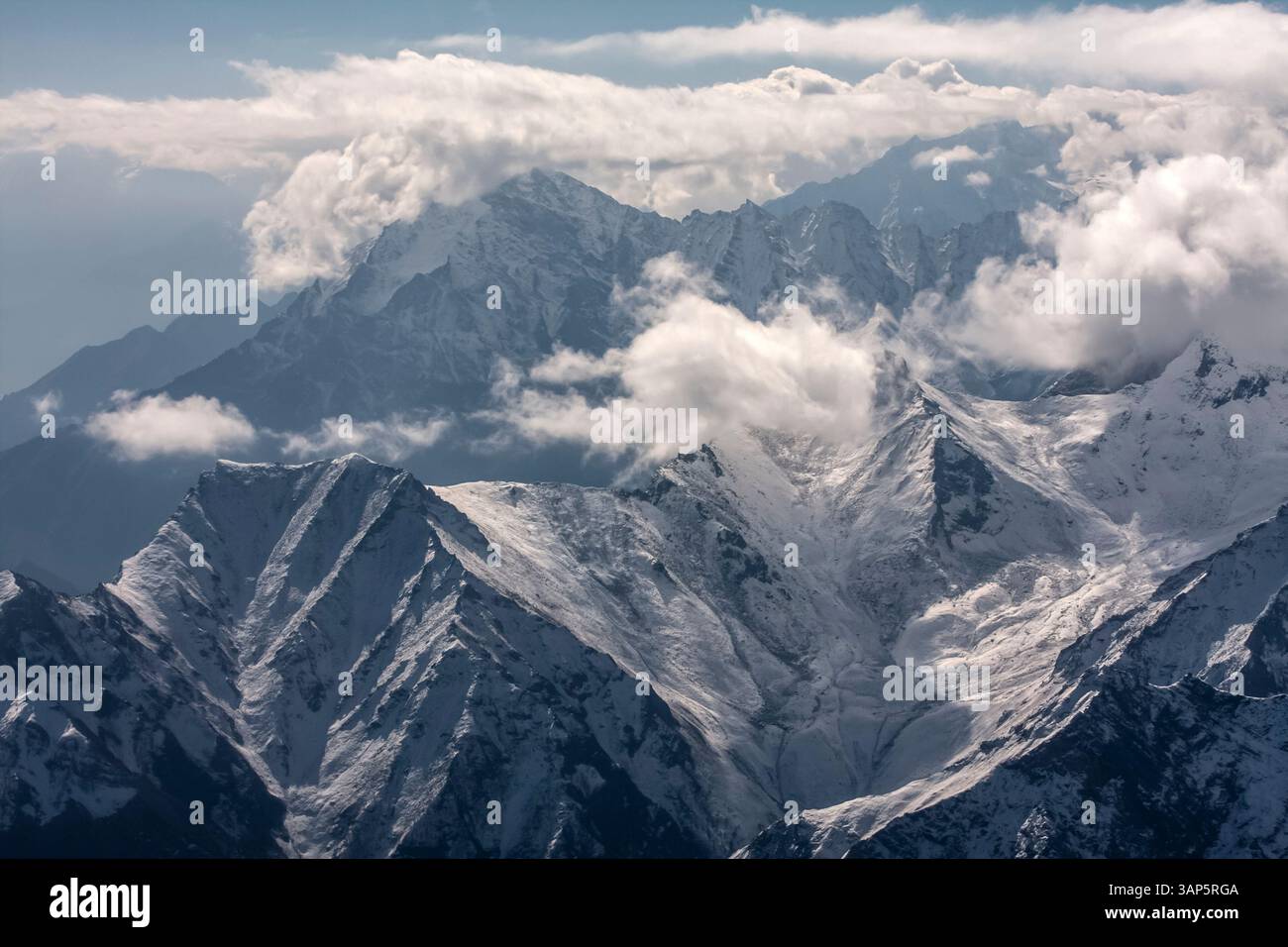 Aerial view of majestic snowcapped peaks and clouds in the breathtaking ...