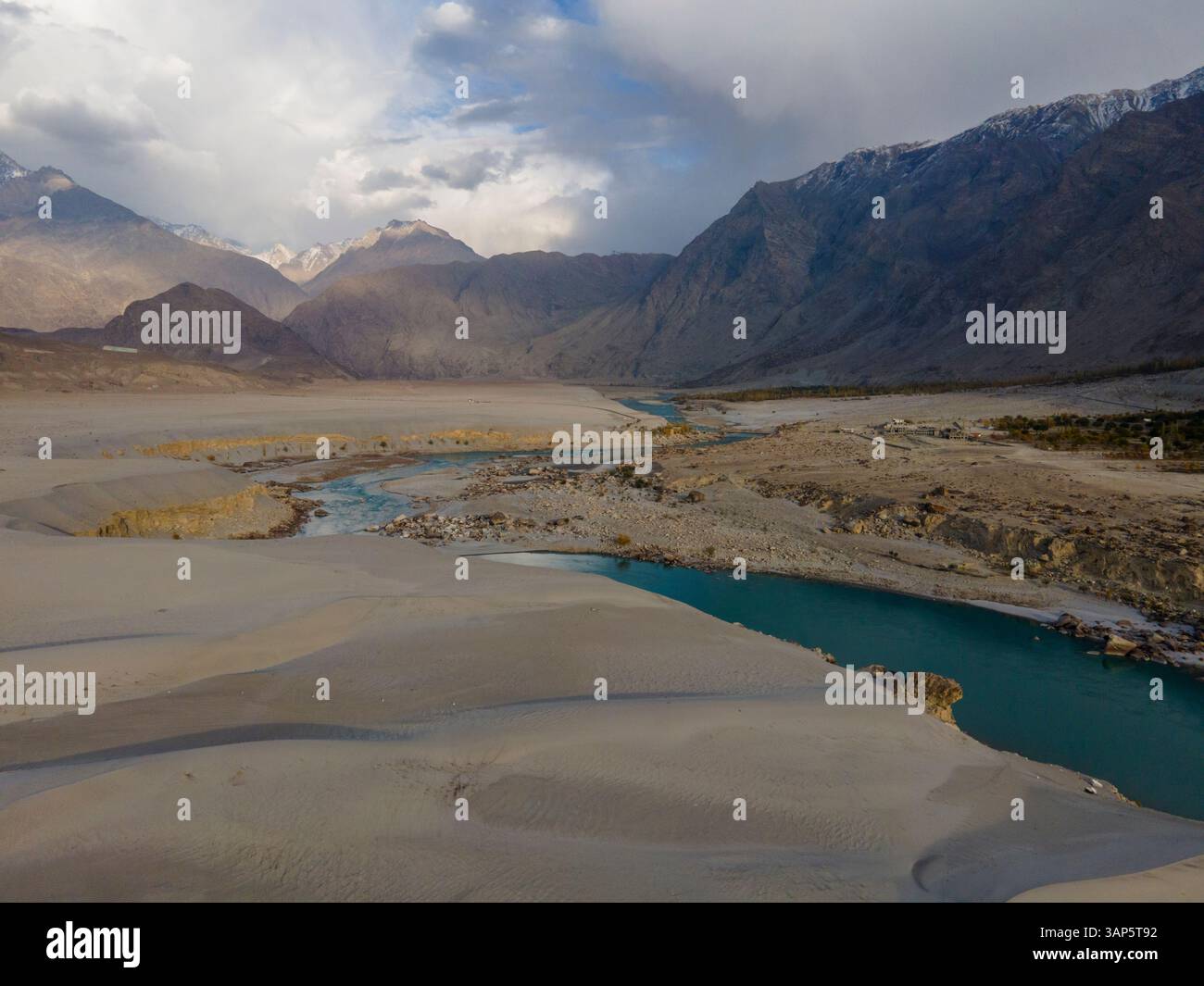 Aerial view of majestic mountains, river, desert, and sand dunes in ...