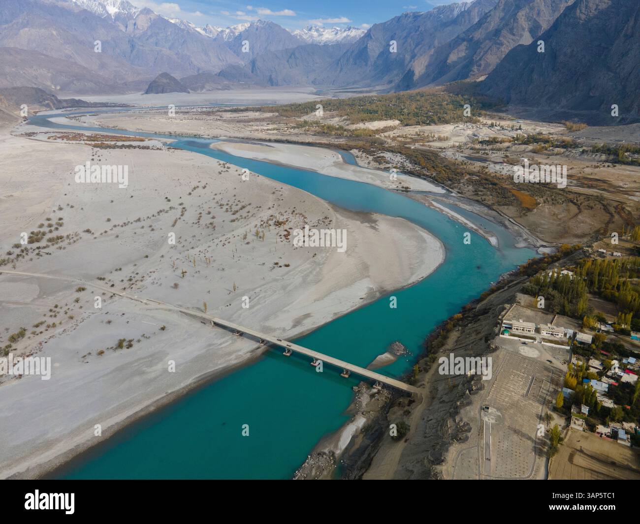 Aerial view of Indus River, bridge, and mountain range in tranquil ...
