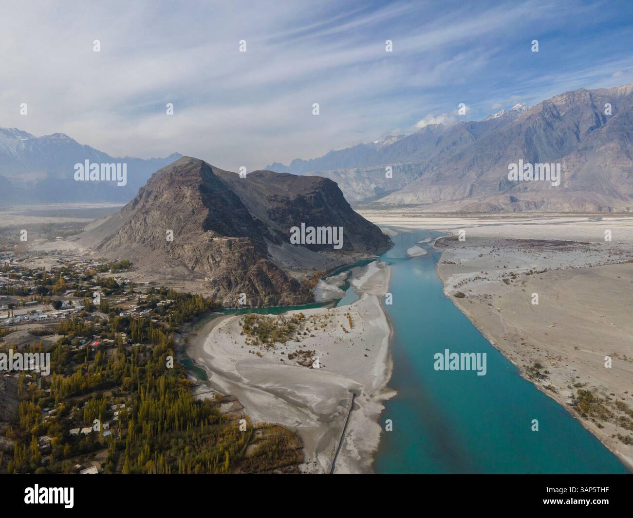 Aerial view of tranquil village by the river Indus in Gilgit-Baltistan ...