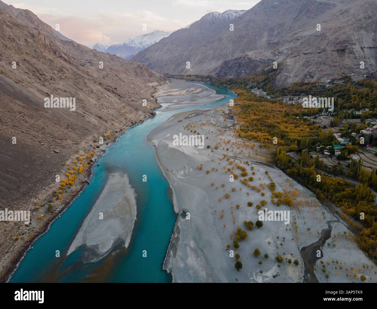 Aerial view of Indus River, mountains, and village in tranquil morning ...