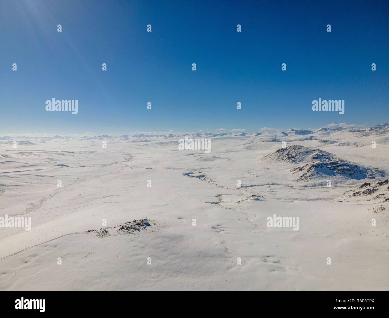 Aerial view of pristine snow-covered mountains and expansive valley ...