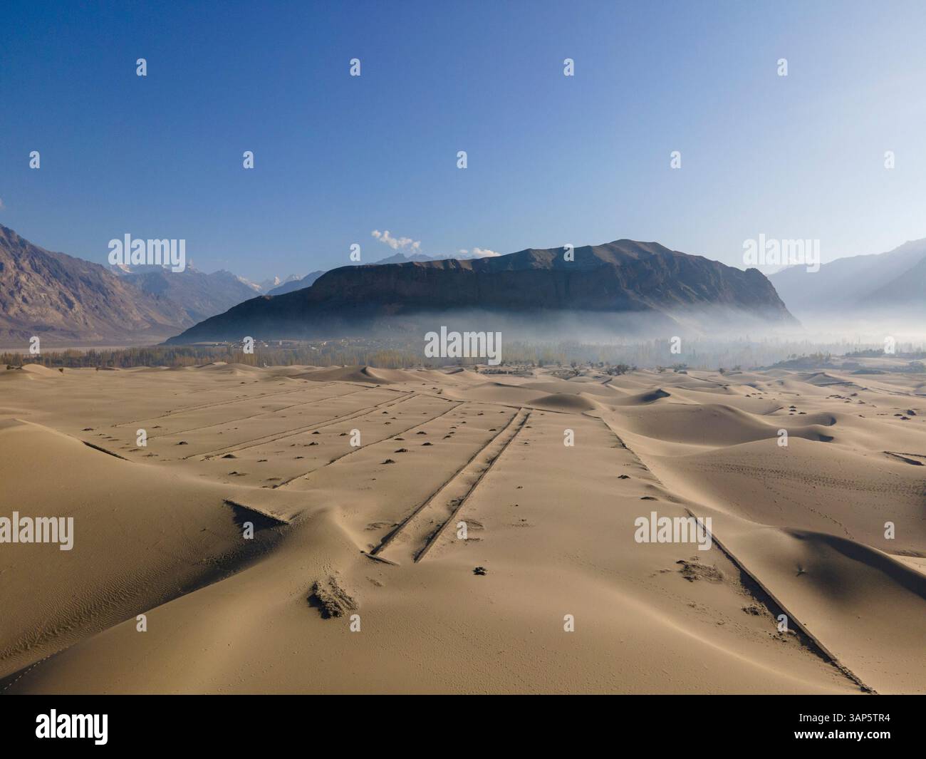 Aerial view of Katpana Desert with majestic mountain range under serene ...