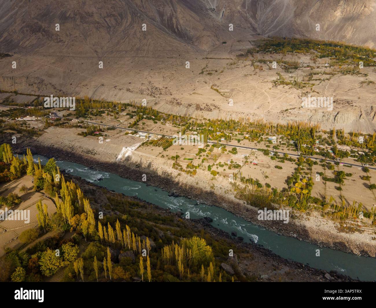 Aerial view of Indus River cutting through the valley with mountainous ...