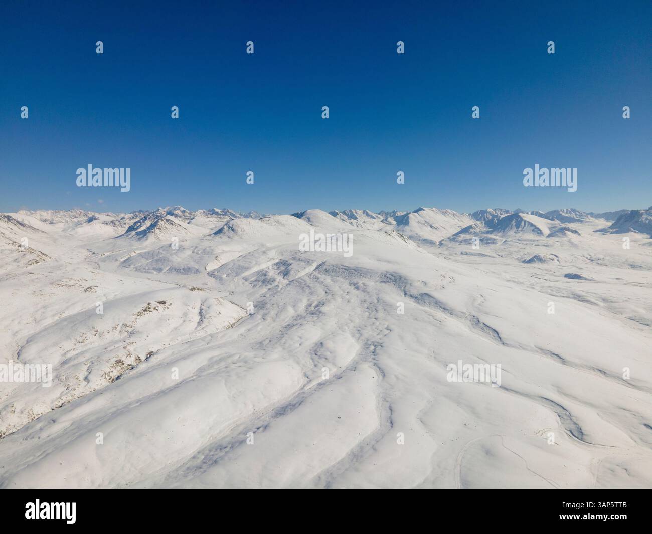 Aerial view of pristine snow-covered mountains in Deosai National Park ...