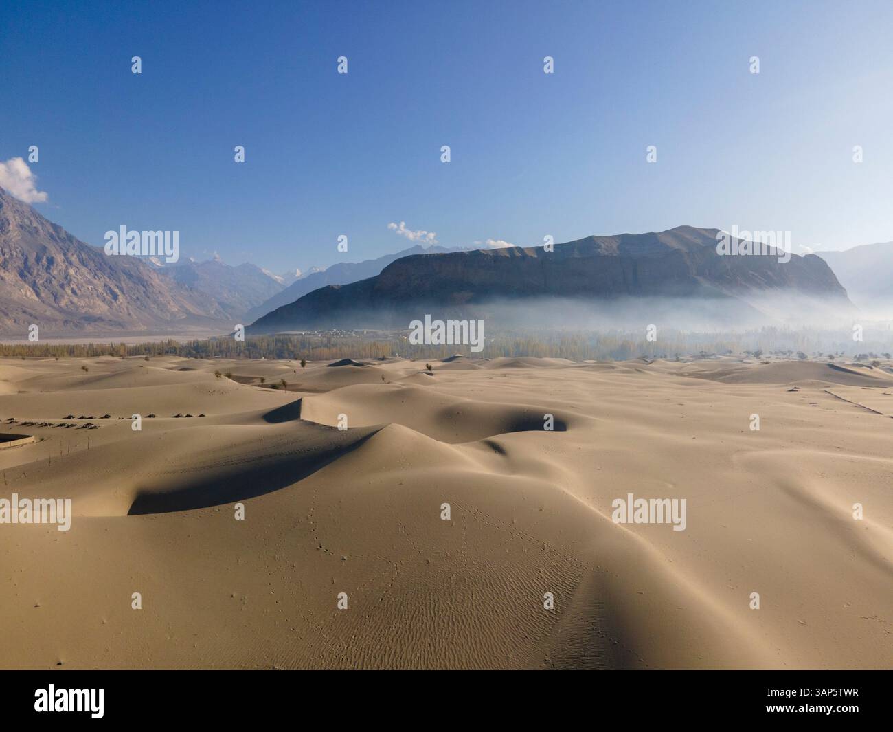Aerial view of Katpana Desert with majestic mountains and vast sand ...