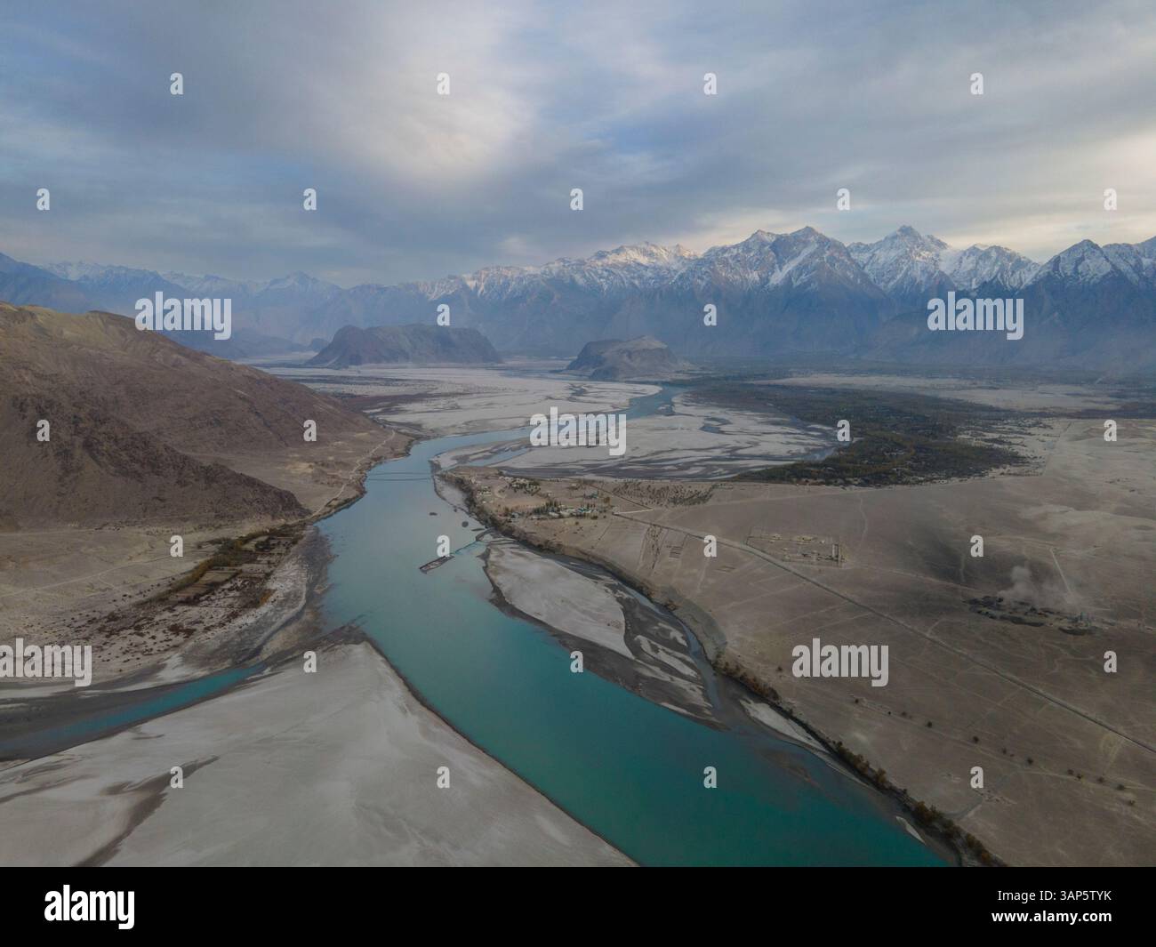Aerial view of Indus River surrounded by majestic mountains and serene ...