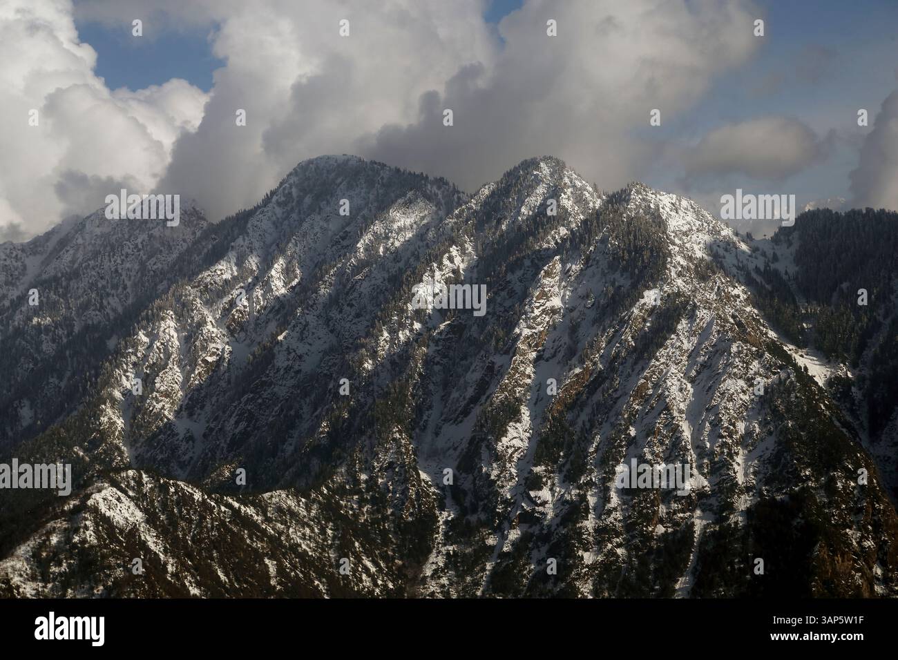 Aerial view of snowy mountain peaks and clouds, Kashmir region ...