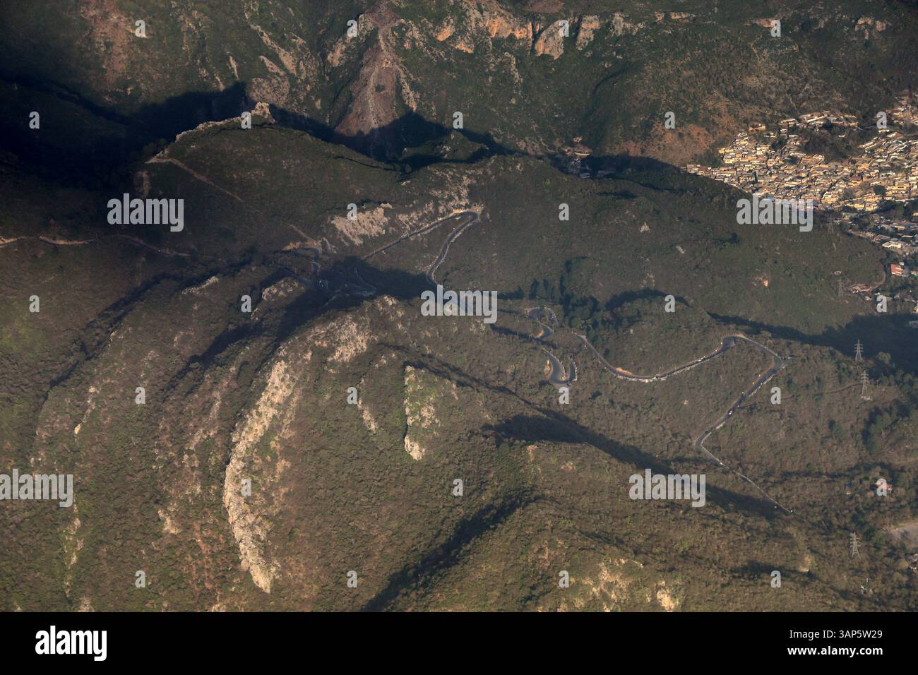 Aerial view of remote mountain range with winding road and rocky ...