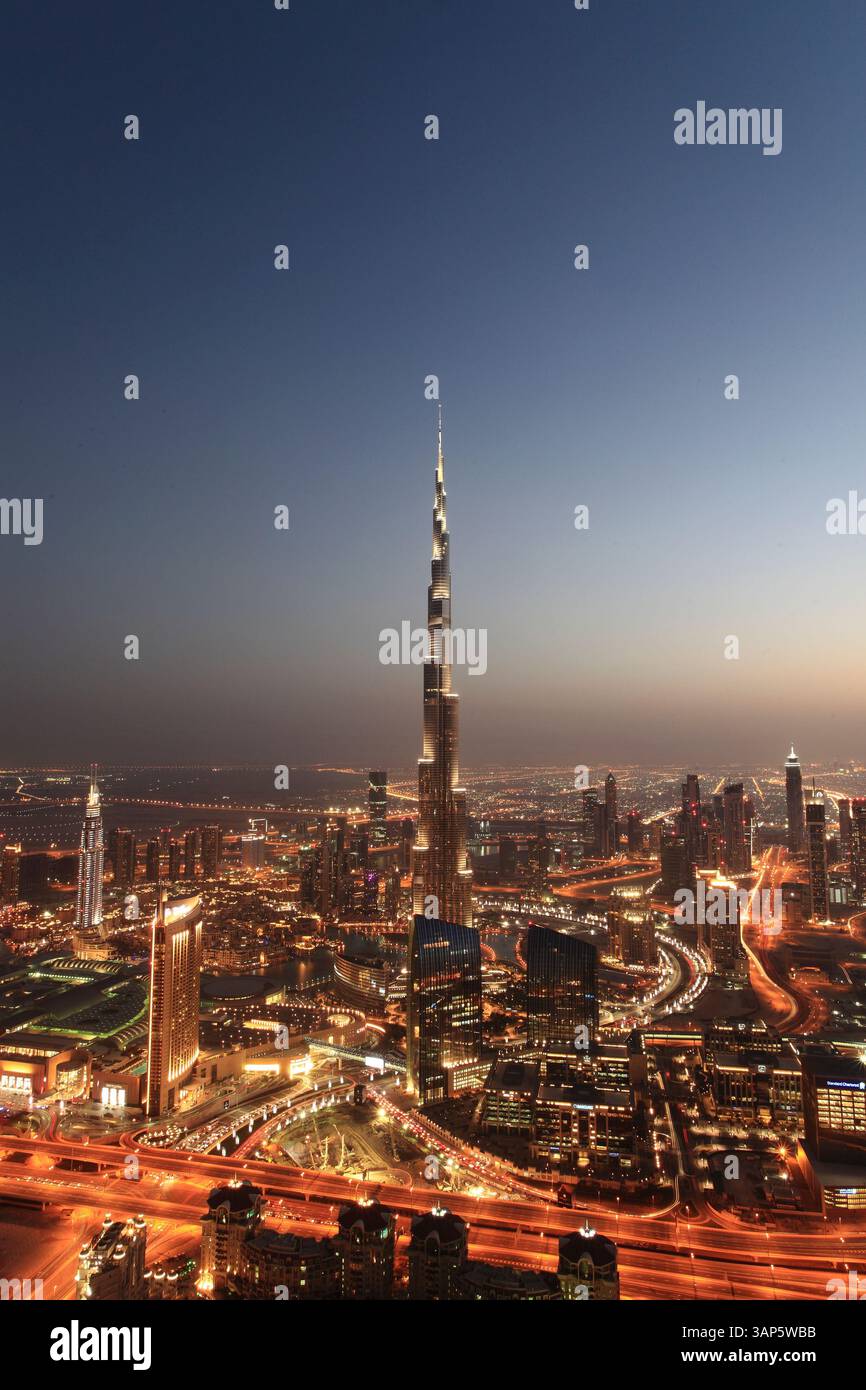 Aerial view of illuminated Dubai cityscape with Burj Khalifa at night ...