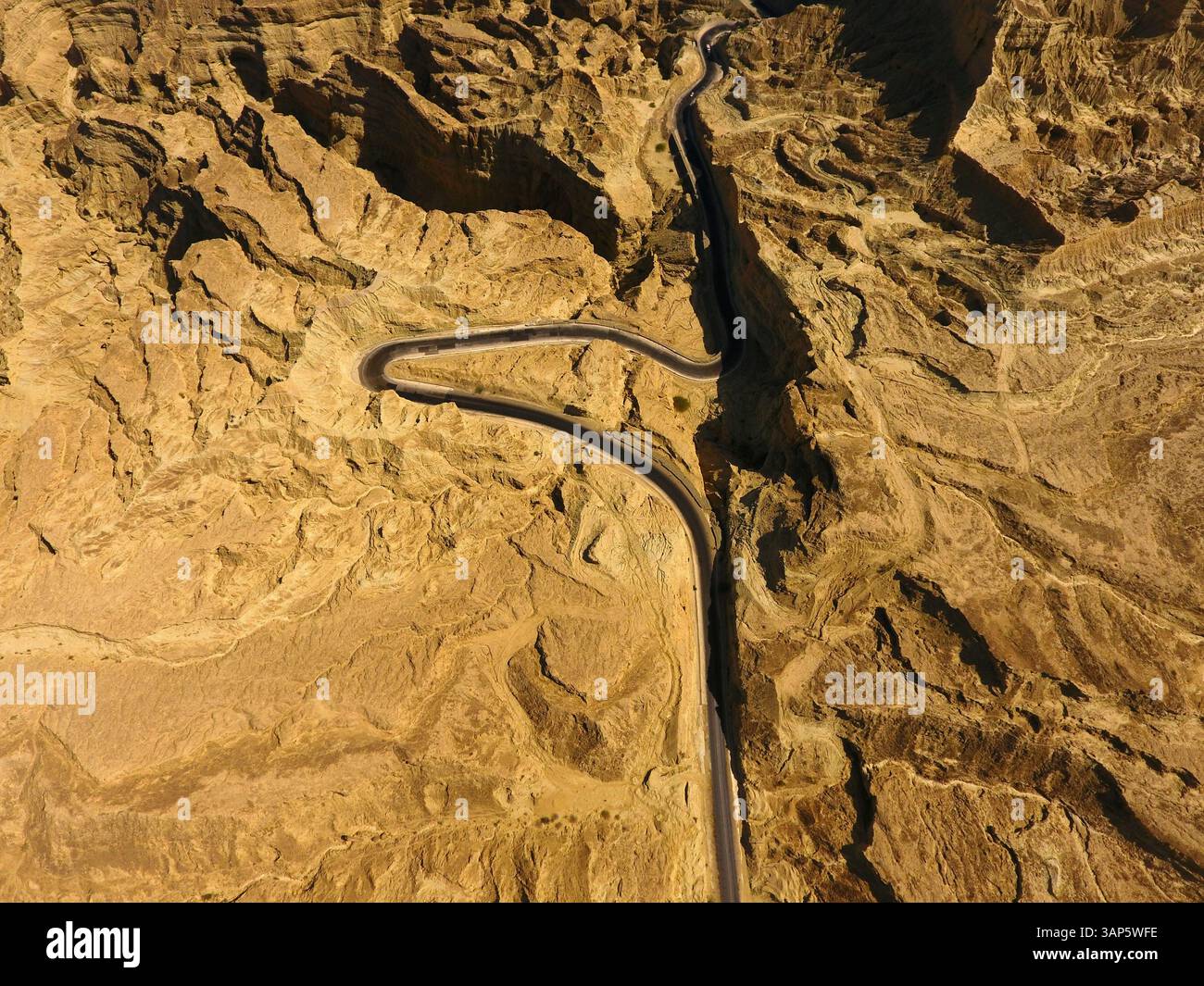 Aerial view of winding road through rocky terrain and mountains, Ormara ...