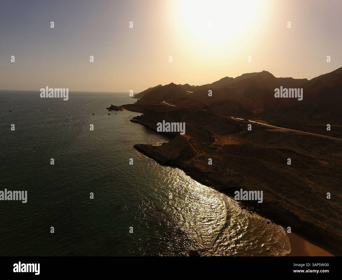 Aerial view of serene coastal sunset over rocky mountains, Balochistan ...