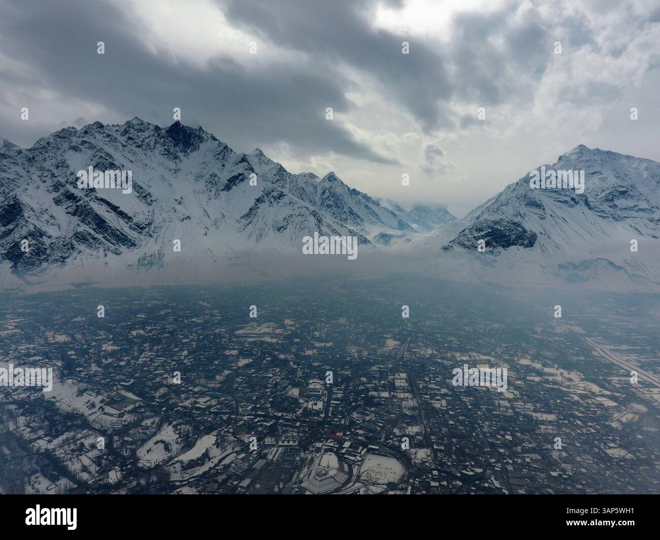 Aerial view of snowy mountains and valley in misty sky, Skardu, Punjab ...