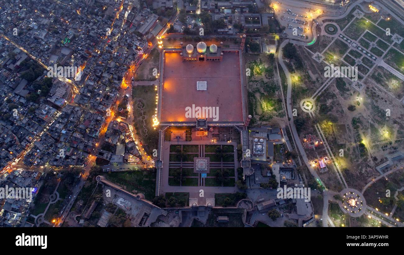 Aerial view of historic Walled city with glowing lights and bustling ...