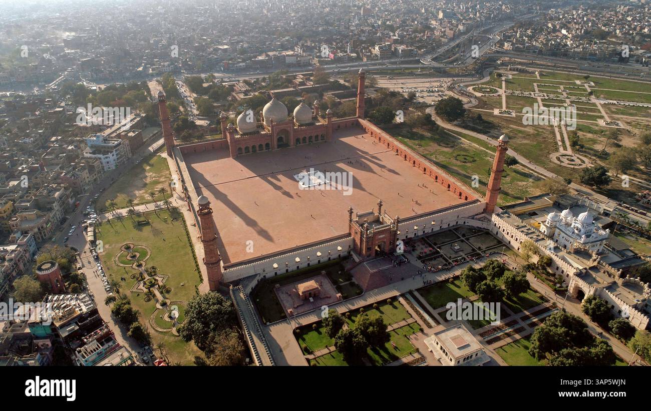 Aerial view of historical mosque with minarets and dome in courtyard ...