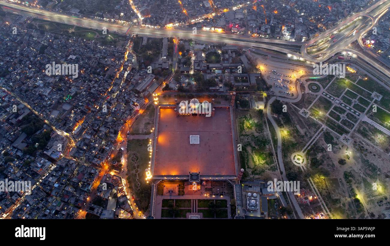 Aerial view of bustling Walled city with glowing lights and greenery, Lahore, Pakistan Stock ...