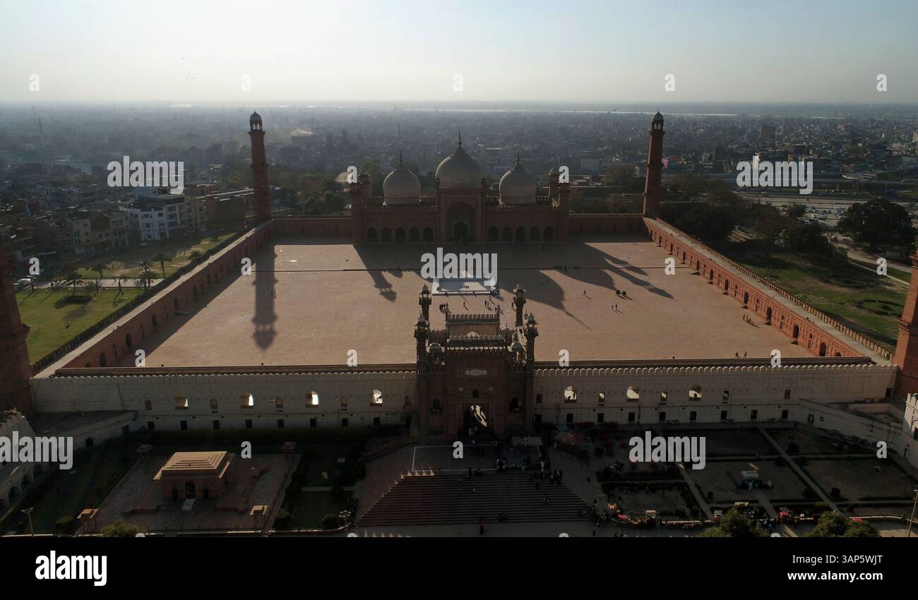 Aerial view of ancient mosque with courtyard, minarets, and domes in ...