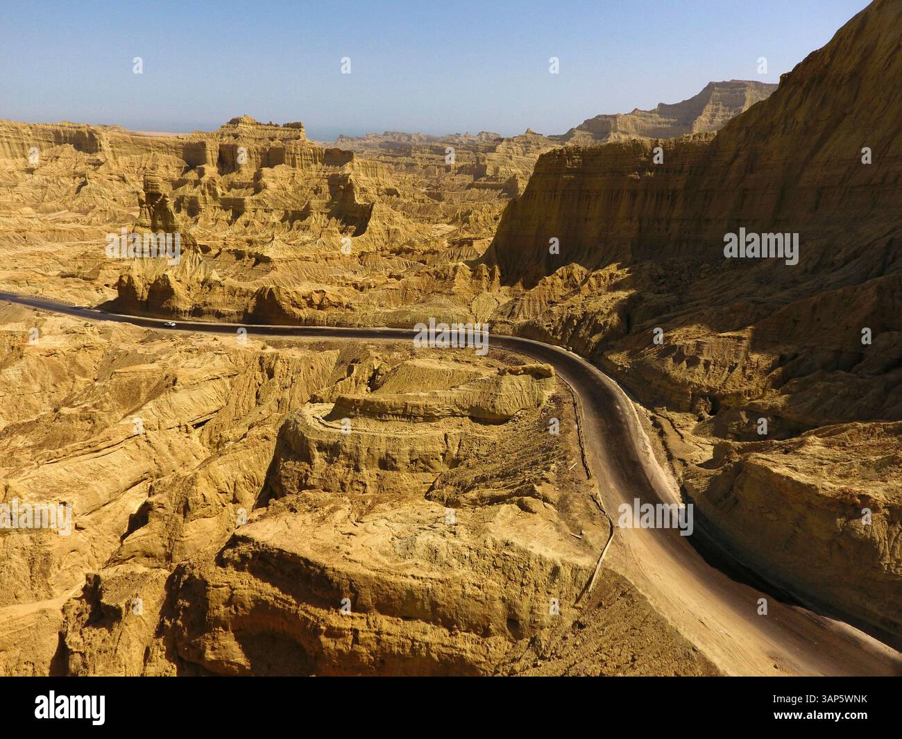 Aerial view of desert road winding through arid mountains, Ormara ...