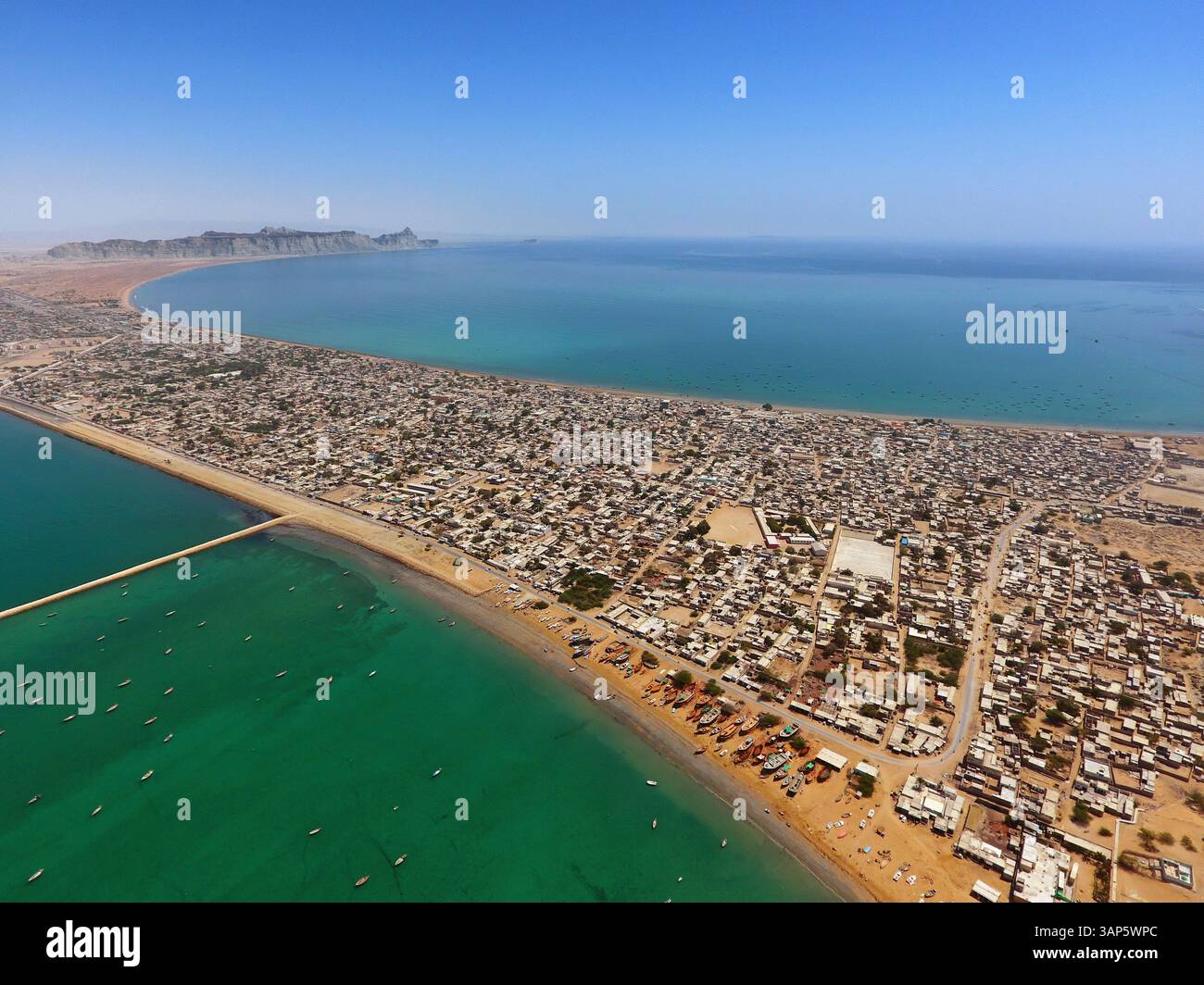 Aerial view of coastal city with sea, buildings, and beach, Paddi Zirr ...
