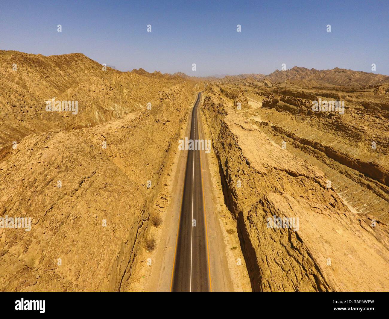 Aerial view of desert road winding through rocky mountains, Ormara ...