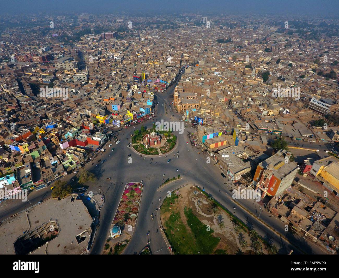 Aerial view of vibrant roundabout and colorful buildings in Multan ...