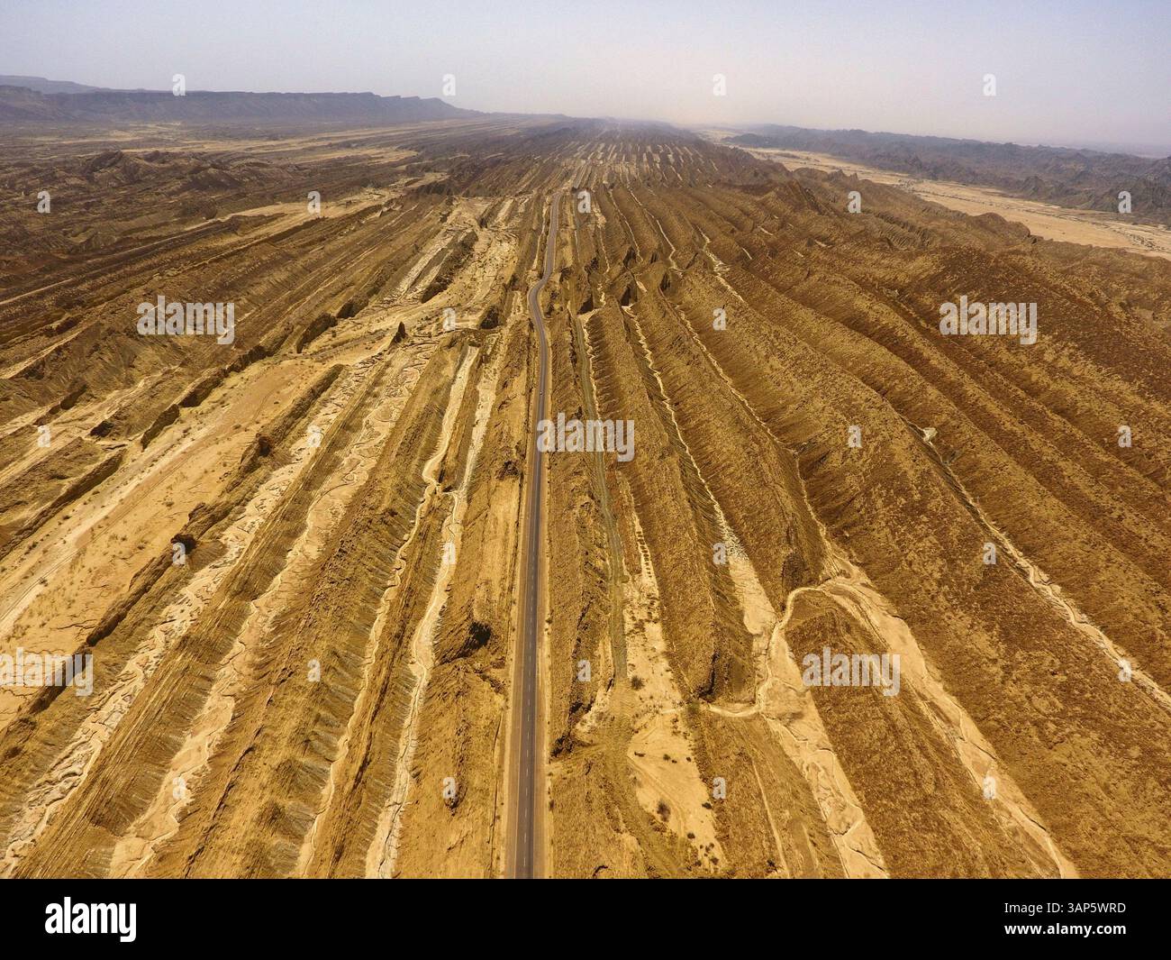 Aerial view of barren, rugged terrain with rocky mountains and desert landscape, Ormara ...