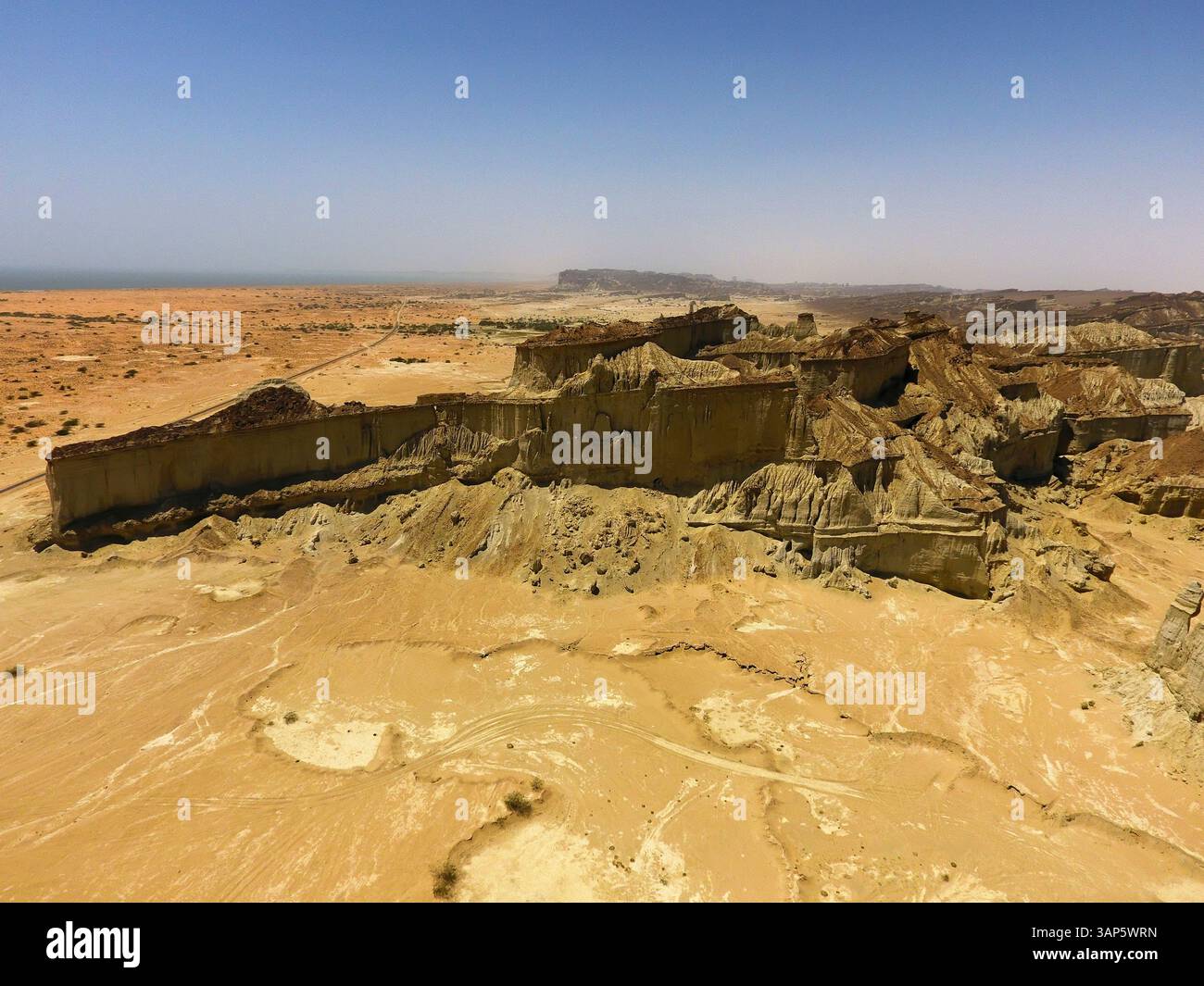 Aerial view of vast desert plateau with cliff formations, Gwadar ...