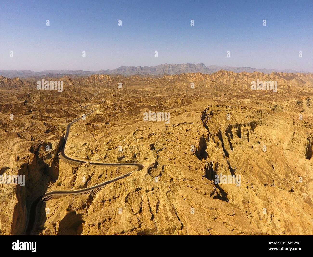 Aerial view of desert road winding through rocky mountains, Ormara ...