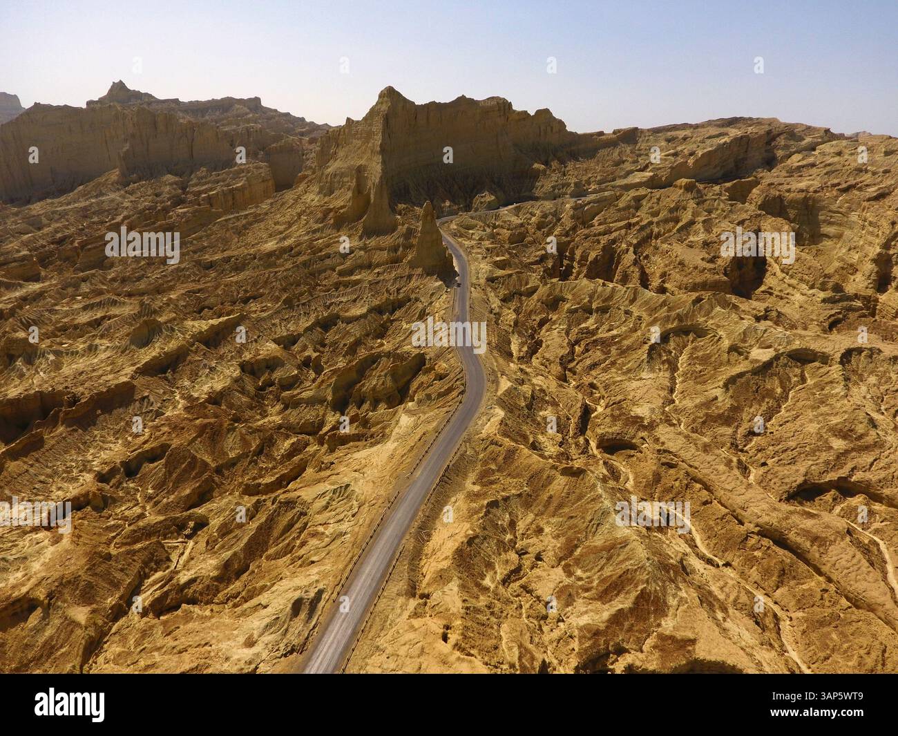 Aerial view of desert road winding through rocky mountains and ...