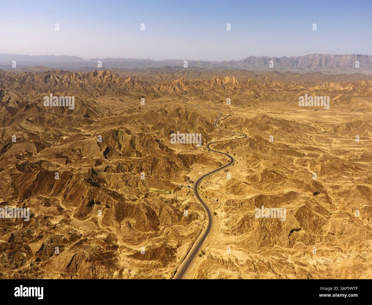 Aerial view of winding road through majestic mountains and desert ...