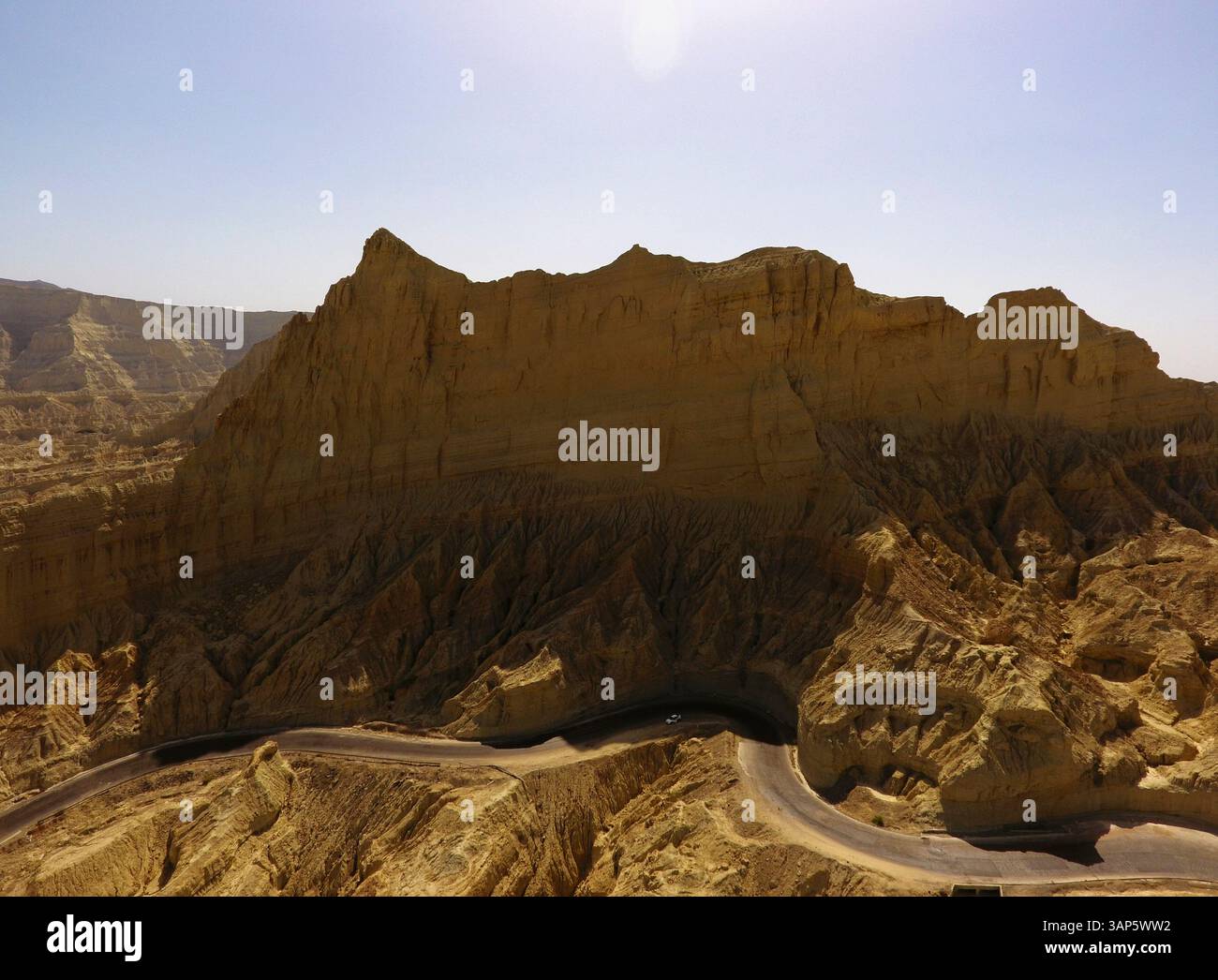 Aerial view of barren, rugged terrain with winding road, Ormara ...