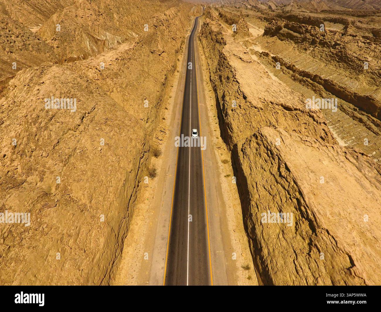 Aerial view of desert road winding through arid mountains, Ormara ...