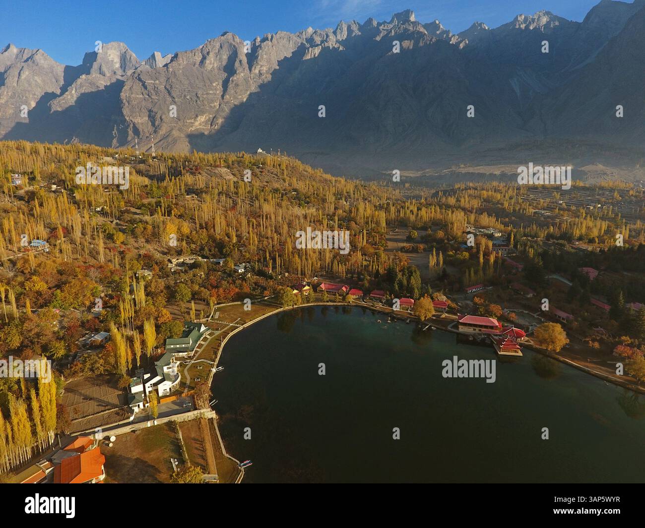 Aerial view of tranquil lake, vibrant autumn trees, and majestic ...