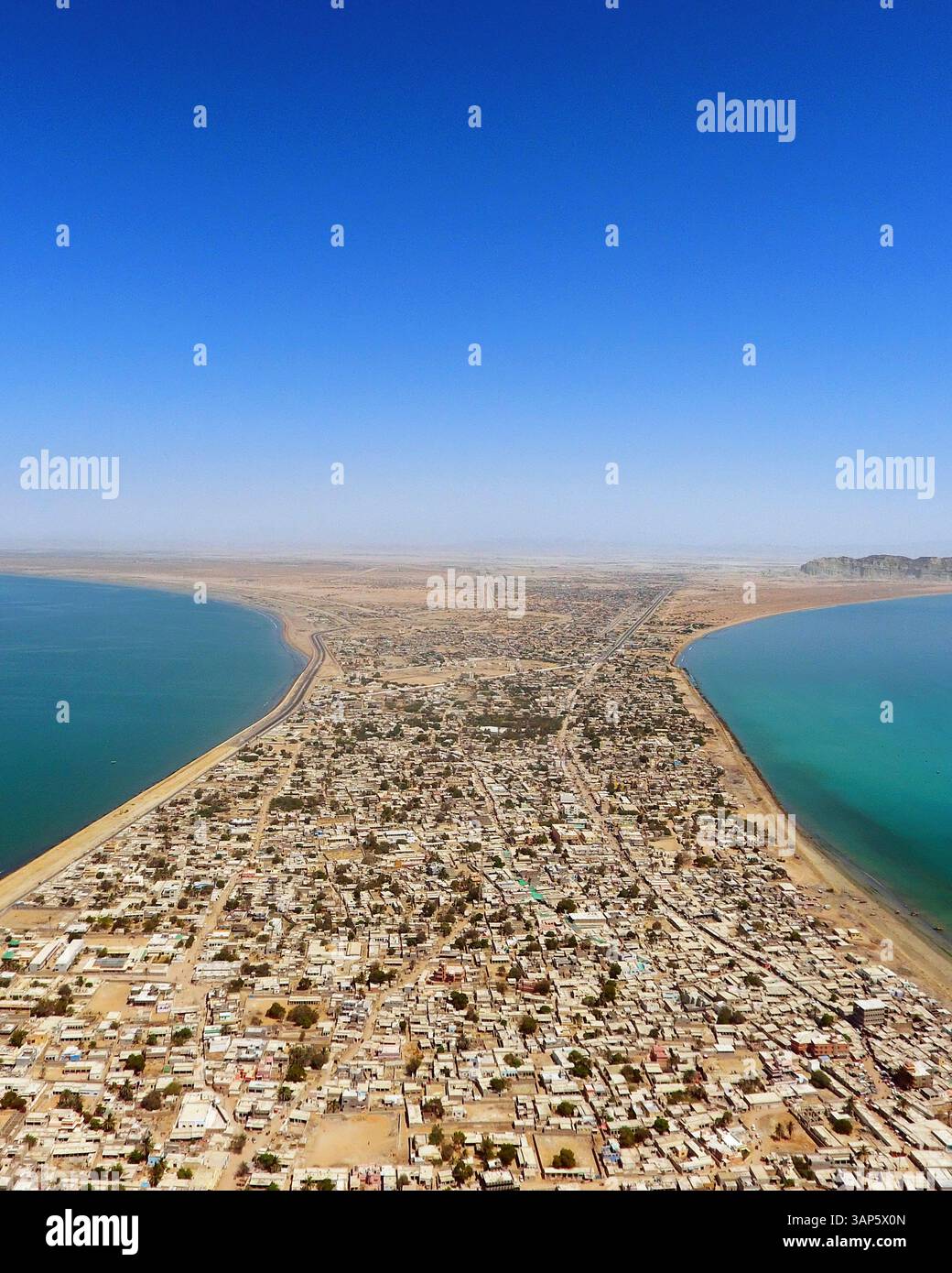 Aerial view of coastal city with sea and buildings along the beach ...
