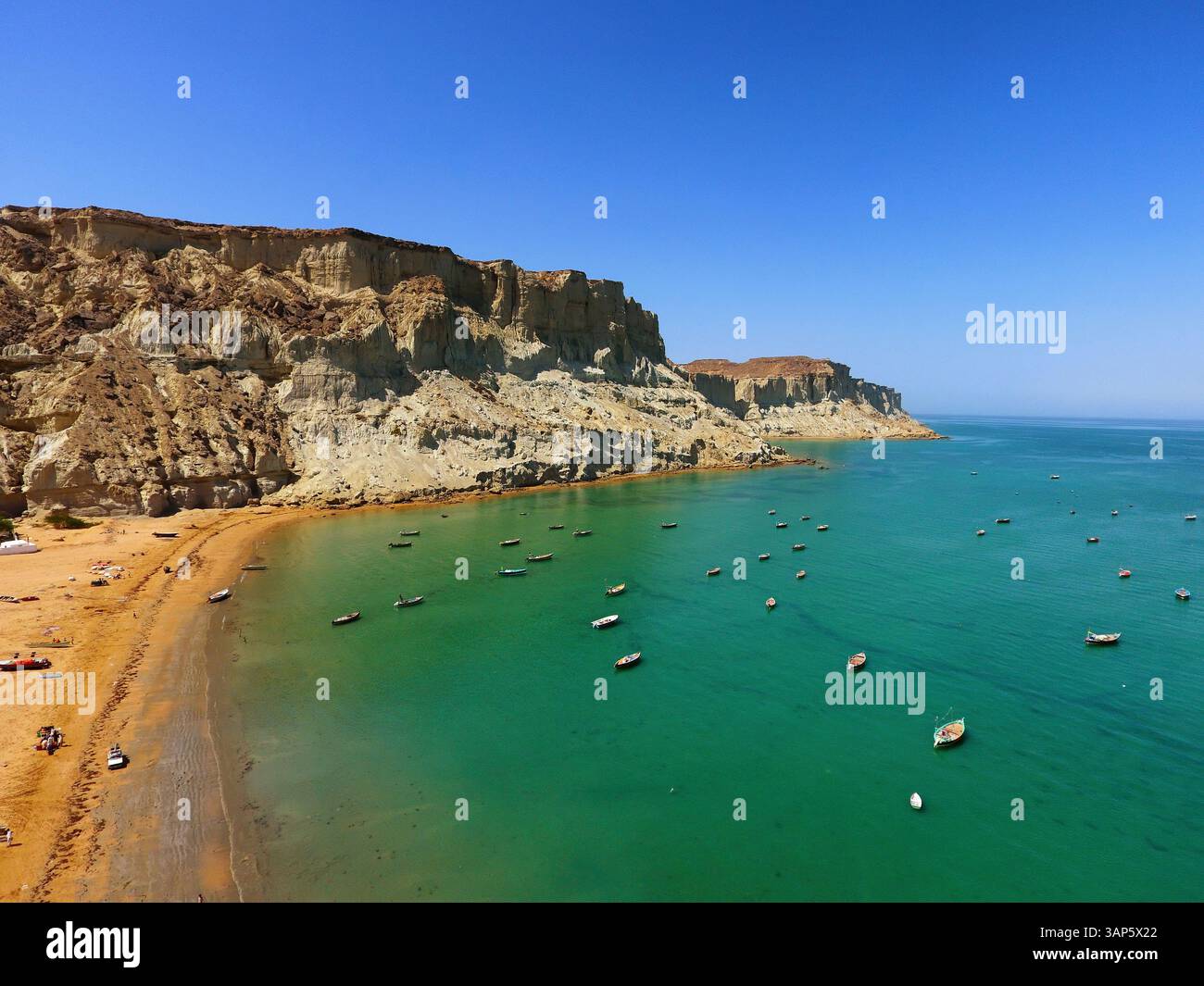Aerial view of deserted beach with fishing boats and turquoise water ...