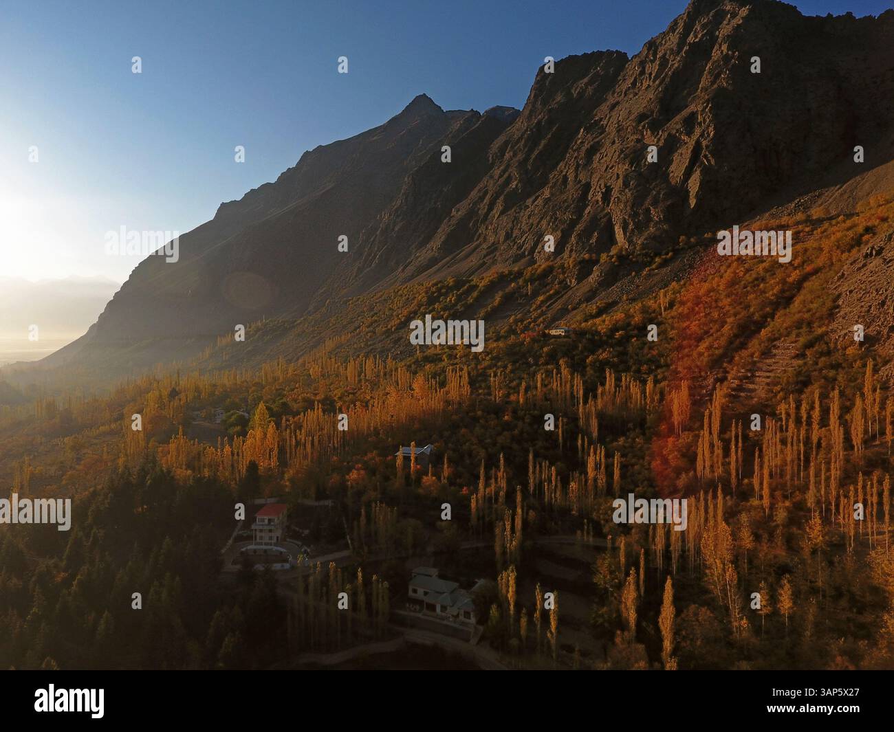 Aerial view of majestic sunset over rocky valley with autumn foliage ...