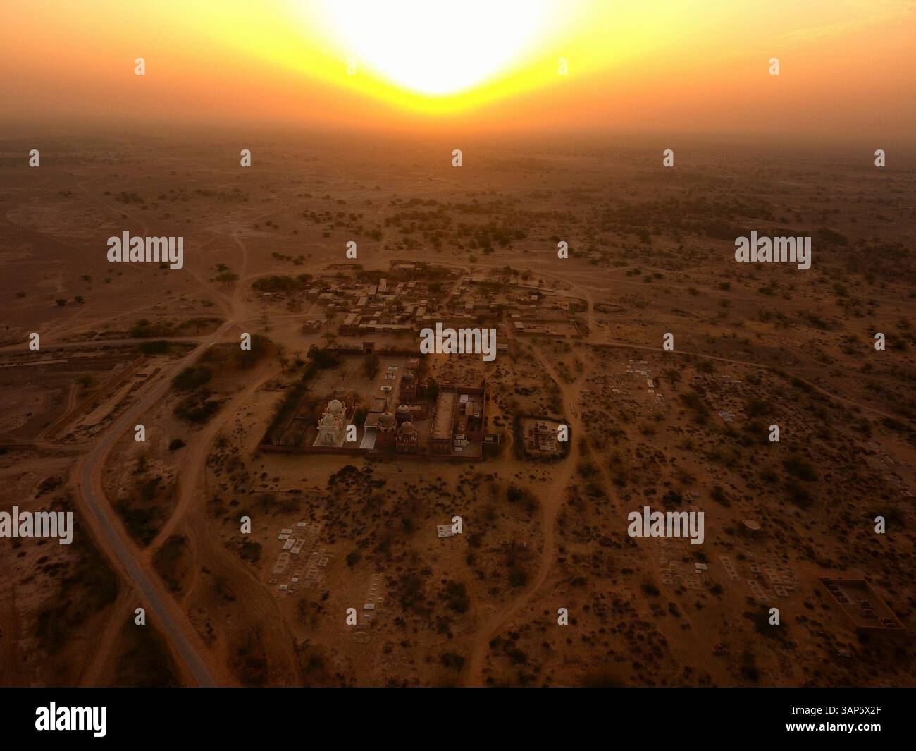 Aerial view of remote village at sunset in desert terrain, Yazman ...