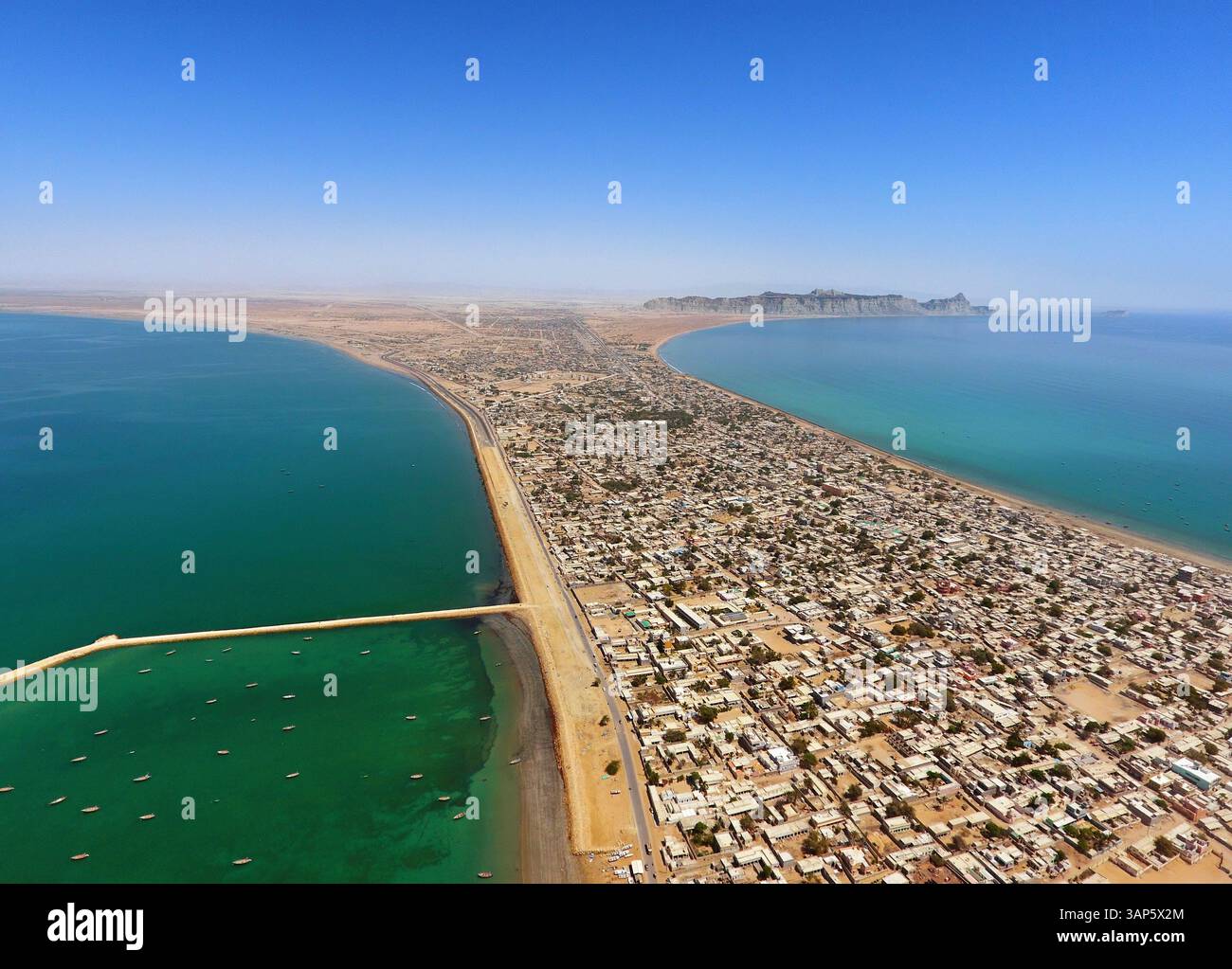 Aerial view of coastal city Gwadar with desert coastline and boats ...