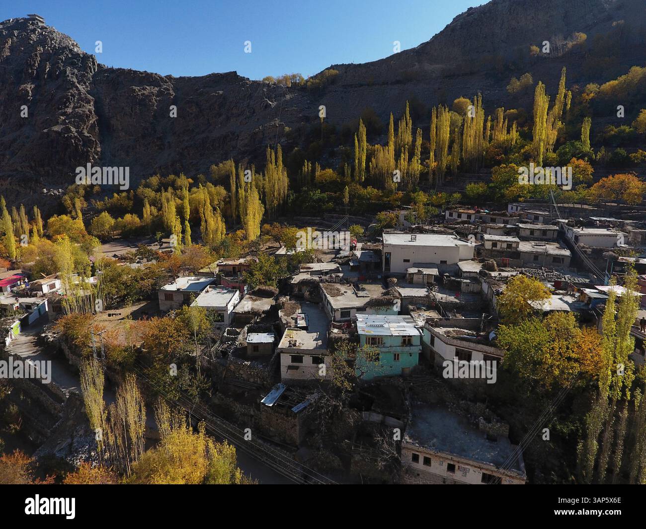 Aerial view of remote village nestled in mountainous region with ...